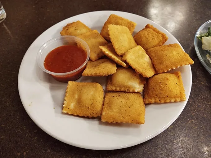 Fried ravioli that crunch like autumn leaves, revealing molten centers that make you understand why people drive across state lines for appetizers.