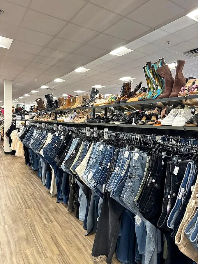 The denim wall—where jeans of every wash and vintage hang like an art installation dedicated to America's favorite pants. 