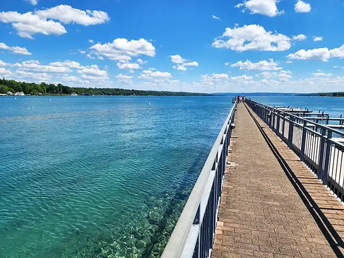 The village pier extends like an invitation into crystal-clear waters, a perfect post-meal stroll destination for working off that extra slice of pie.