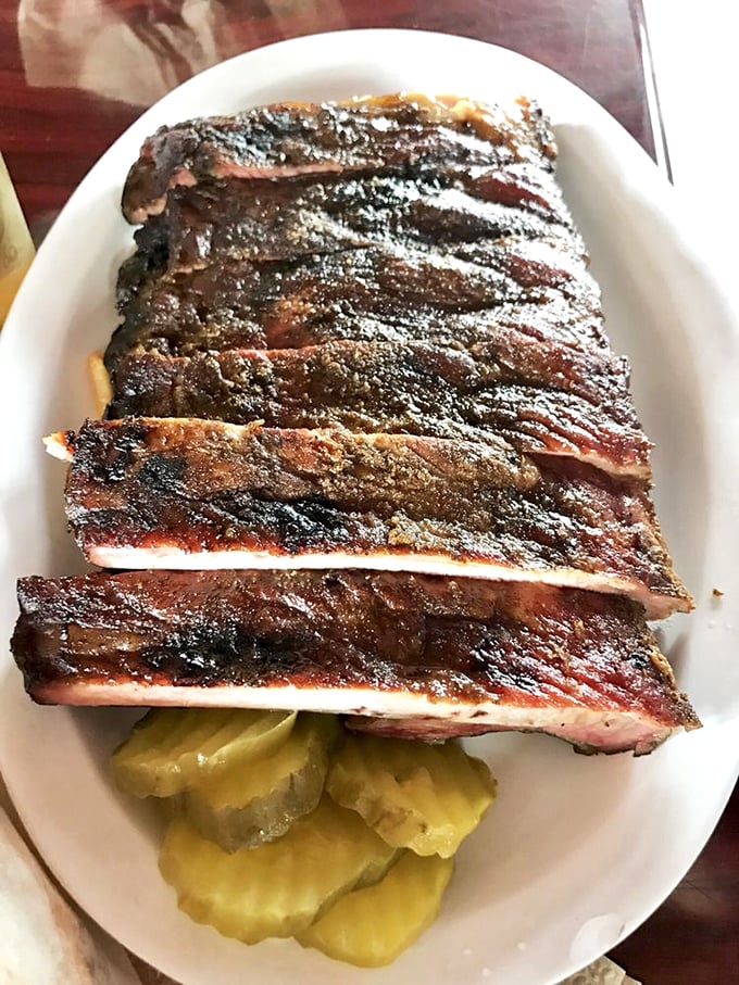 These ribs aren't falling off the bone—they're clinging to it with dignity. The perfect resistance when you bite, then surrender with smoky grace.