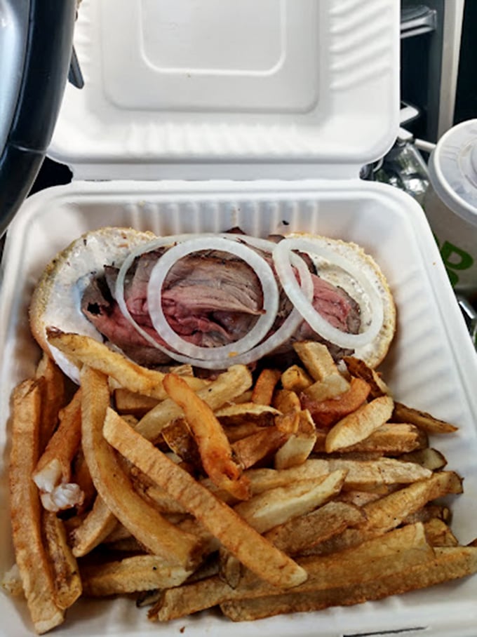 The classic pairing of paper-thin beef with raw onions creates that perfect bite where texture meets flavor in a sandwich symphony.