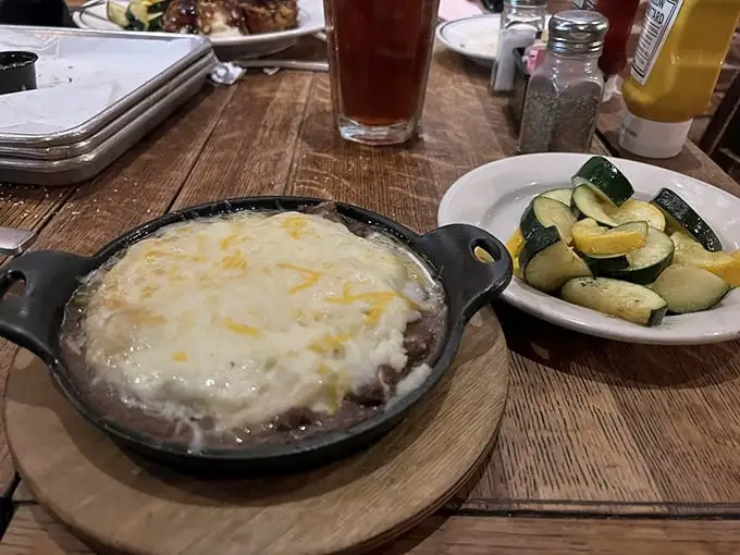 A perfect marriage: shepherd's pie with its molten interior and golden top alongside fresh zucchini that pretends this meal has nutritional balance.