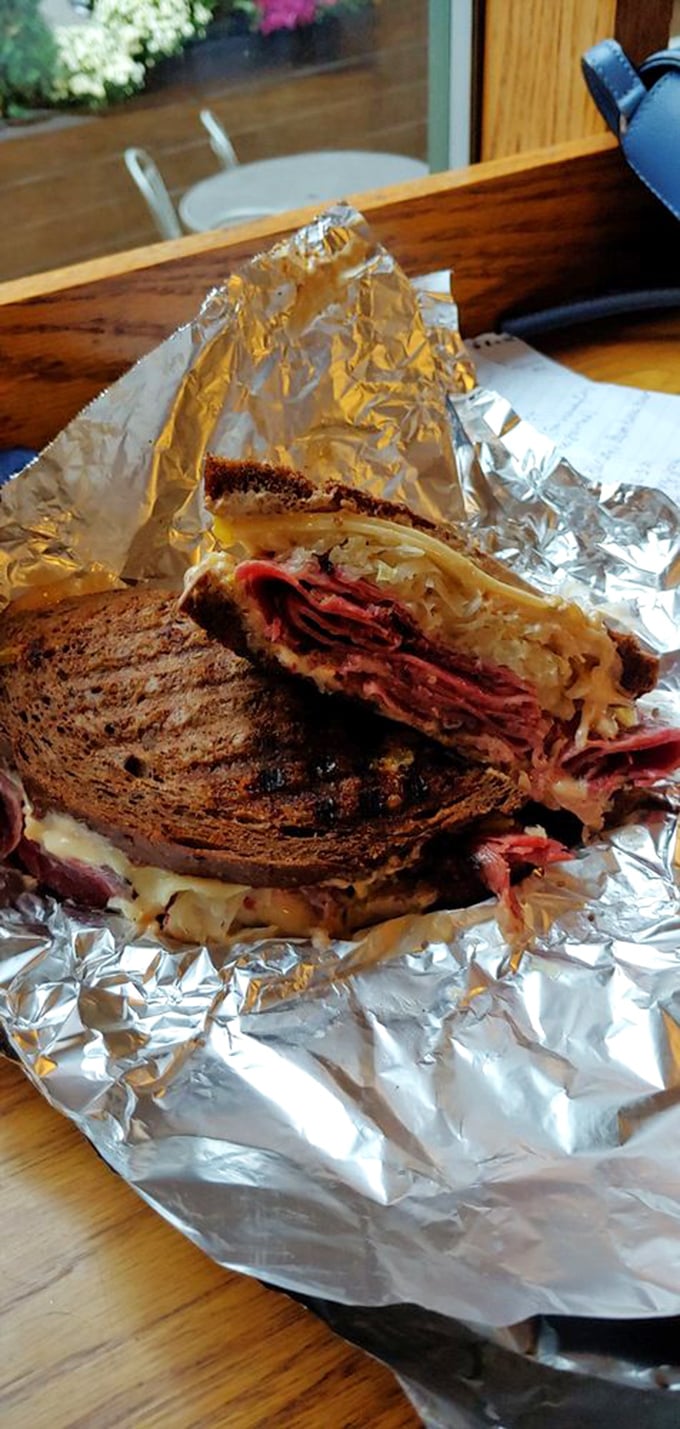 That moment when your sandwich requires both hands and your full attention—this Reuben demands nothing less.