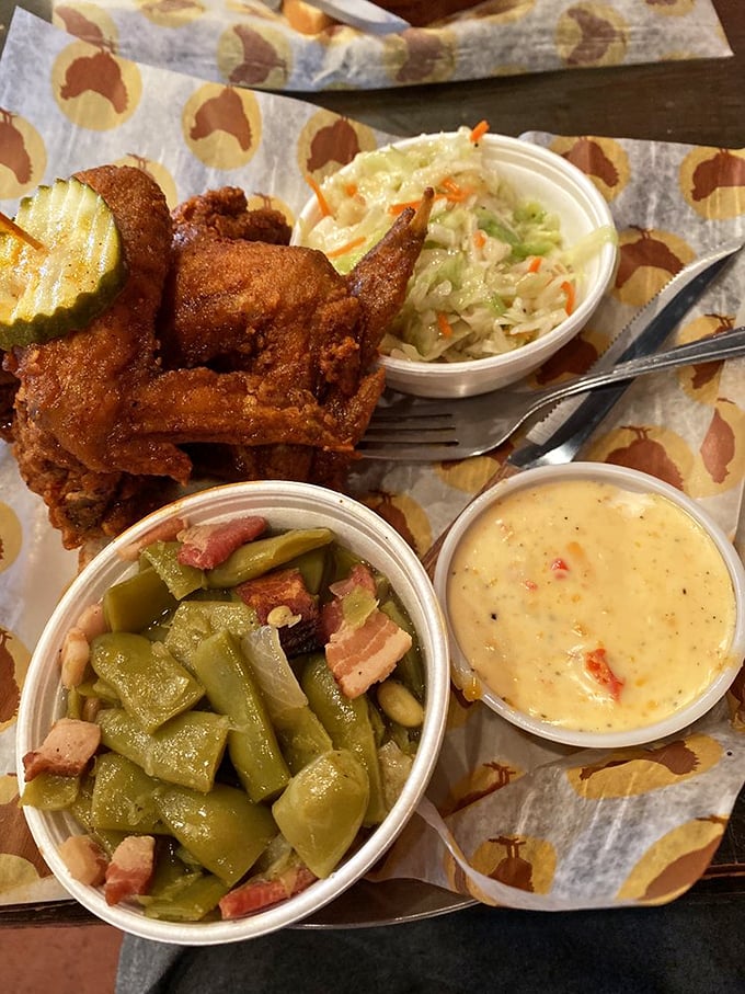 That pickle isn't just garnish—it's the cool, crisp lifeguard standing by as you dive into the deep end of Nashville-style heat. The slaw offers sweet relief.