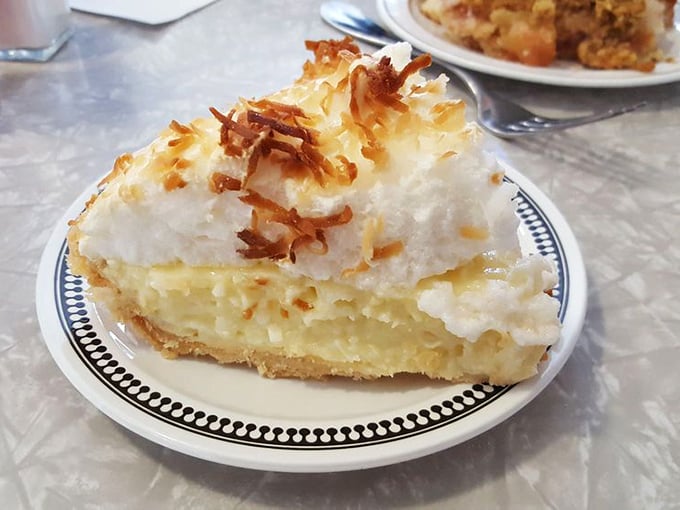 Coconut cream pie with toasted coconut flakes—like a tropical vacation that doesn't require sunscreen or awkward family photos.