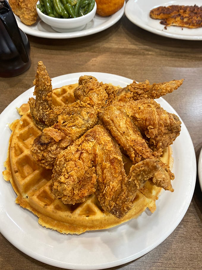 Chicken and waffles—the culinary power couple that proves opposites don't just attract, they create magic. That golden-brown chicken is practically winking at me.