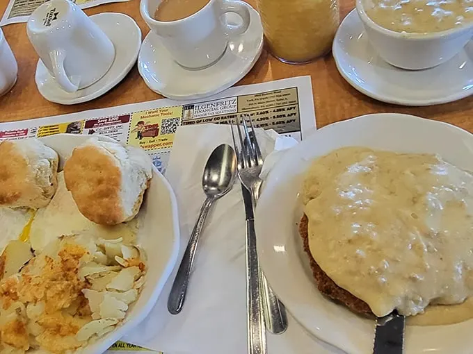 This is what diner dreams are made of – golden country fried steak with gravy cascading over the edges like a delicious waterfall. 