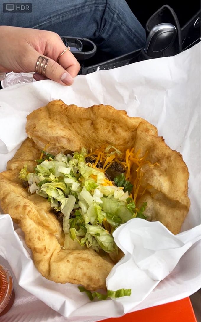 Taco Tuesday, elevated! Crispy-yet-tender fry bread cradles seasoned beef, fresh lettuce, and cheese—a handheld masterpiece that demands both napkins and respect.