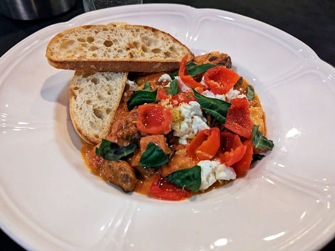 This isn't just braised beef—it's a masterclass in patience. The tender meat, bright tomatoes, and crusty bread create the holy trinity of comfort food. 
