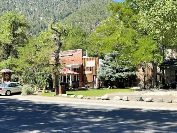 Genoa's historic buildings huddle together against the mountainside, creating a frontier-era skyline that whispers tales of Nevada's earliest days.