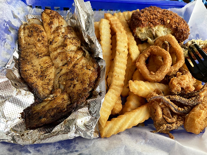 The ultimate marriage of land and sea—lumpy crab cake embracing crispy fries like they were always meant to be together.