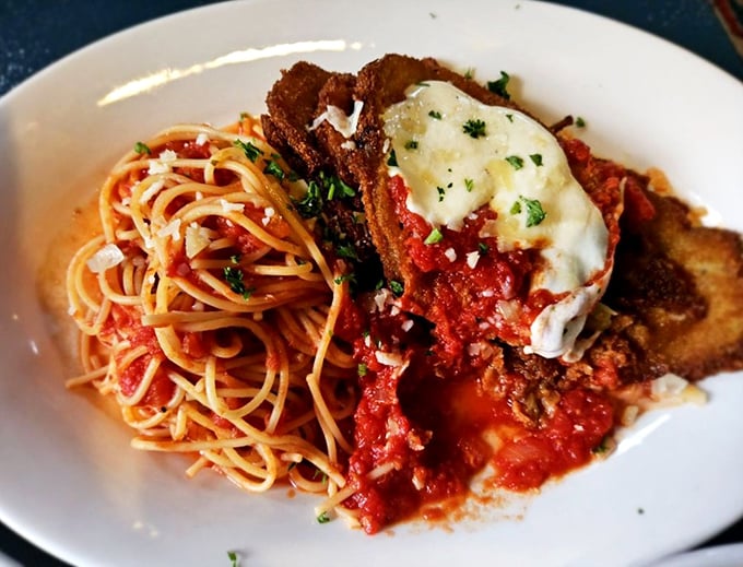 Italian grandmothers everywhere would nod approvingly at this eggplant parmesan—thin, crispy cutlets nestled against al dente pasta like old friends catching up.