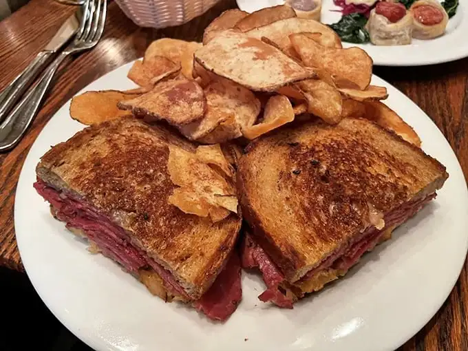 The Reuben sandwich: where corned beef meets melted Gruyère in a dance so beautiful it deserves its own Connecticut state holiday. House chips included for applause.