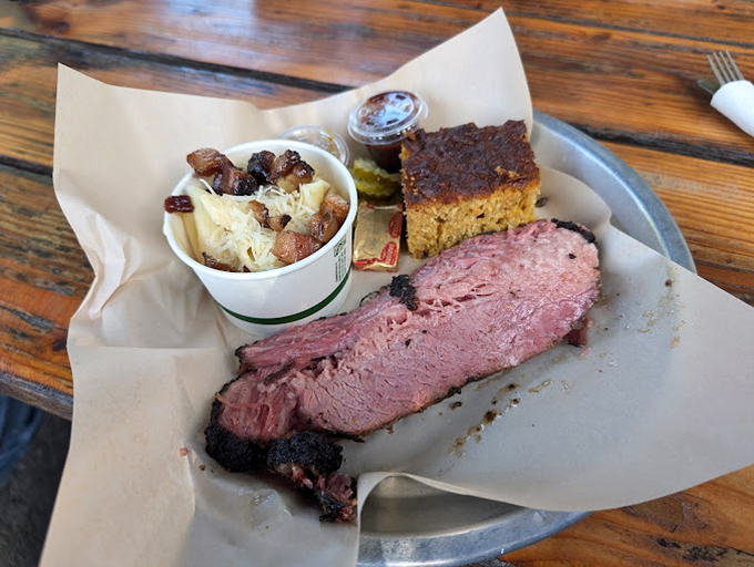 Brisket with that telltale pink smoke ring that barbecue aficionados chase like bird watchers after a rare sighting. Served on butcher paper—as it should be.