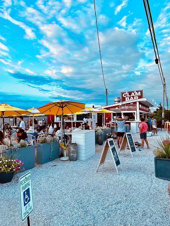The Clam Bar's humble red-and-white shack proves great seafood needs no fancy trappings – just fresh catch and ocean breezes.