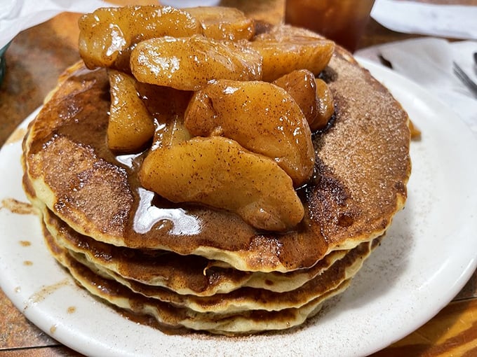 Pancakes topped with cinnamon apples that would make your grandmother both proud and slightly jealous. Breakfast architecture at its finest.