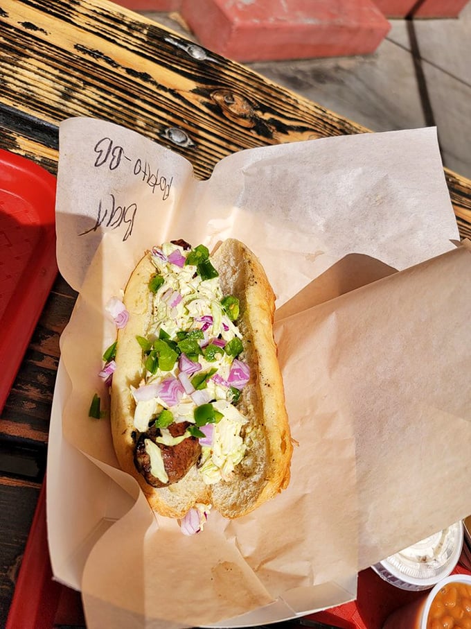 This bratwurst sandwich isn't just lunch—it's edible history. The purple onions add both color and a zingy counterpoint to the savory sausage.