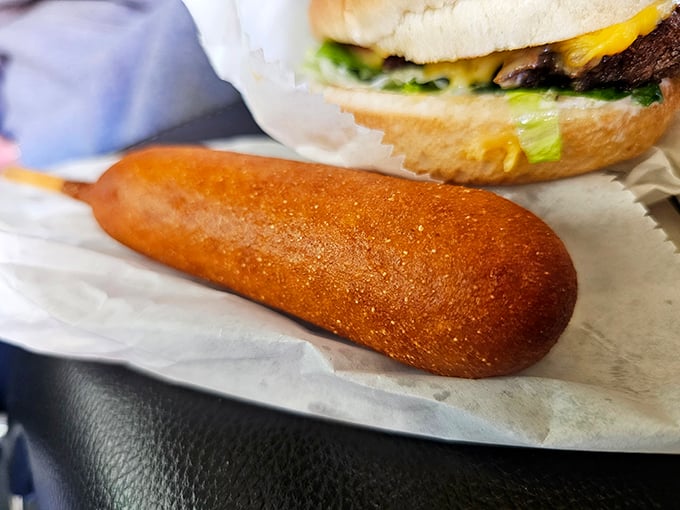 The humble corn dog – America's contribution to food-on-a-stick culture – golden, crispy, and mysteriously satisfying in ways fancy food never will be.