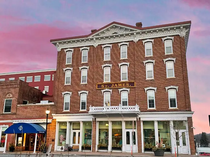 The St. James Hotel stands like a Victorian time capsule, its brick facade having witnessed more river history than most history books contain.