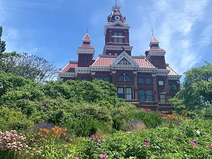 Old City Hall's distinctive towers and Victorian grandeur stand guard over gardens that bloom with Pacific Northwest abundance.