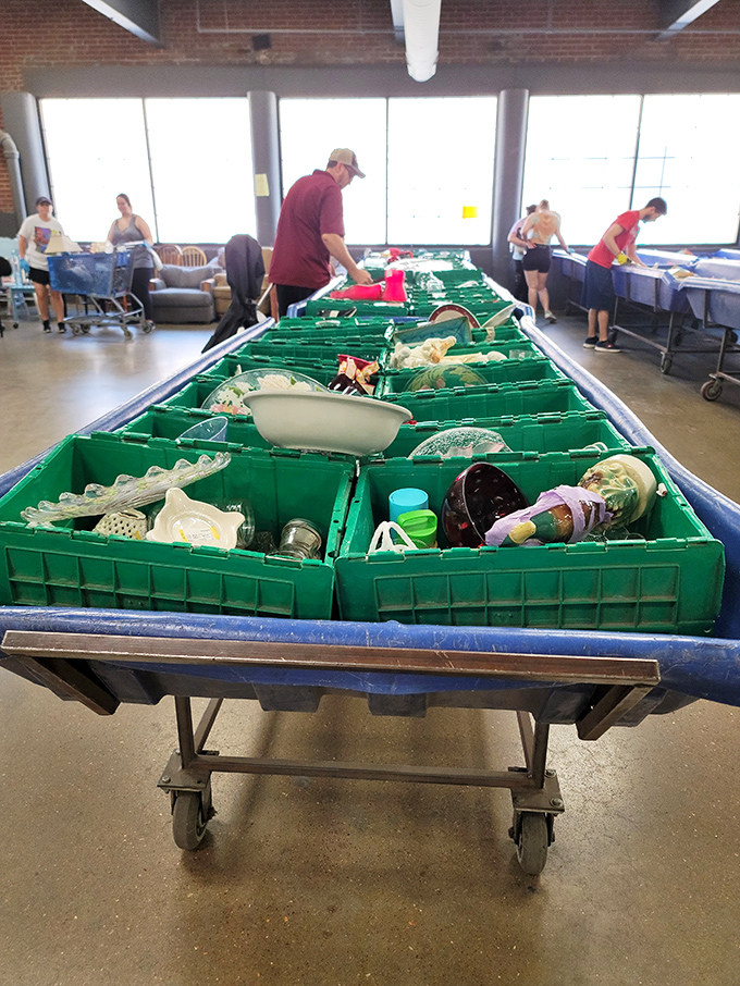 Green sorting bins filled with glassware and kitchen treasures – somewhere in there might be the serving dish your grandmother once owned.