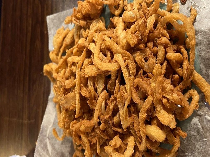 Onion rings so crispy they deserve their own fan club. These golden halos aren't just a side dish—they're a religious experience for the taste buds.
