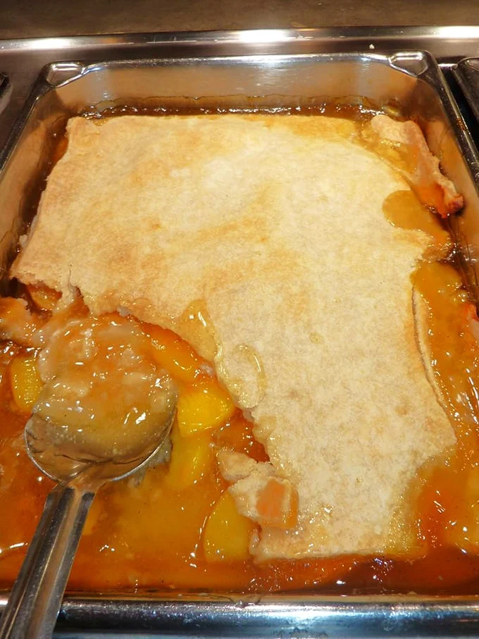 This peach cobbler isn't just dessert—it's edible sunshine with a golden crust. The kind of sweet ending that makes you contemplate a second round.