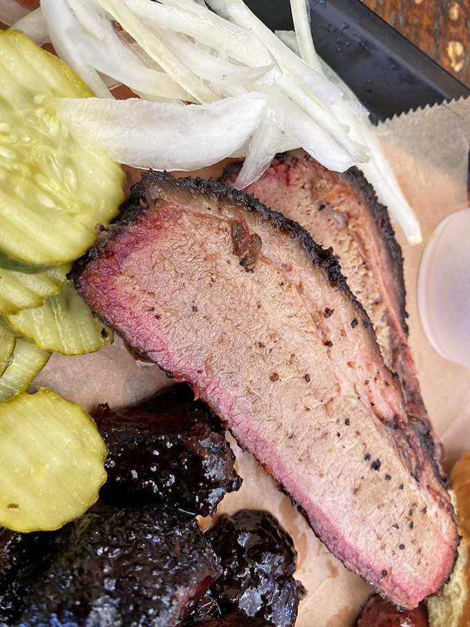 That smoke ring isn't just pink—it's the barbecue equivalent of a Michelin star. The pepper-crusted bark is what dreams and extra napkins are made for.