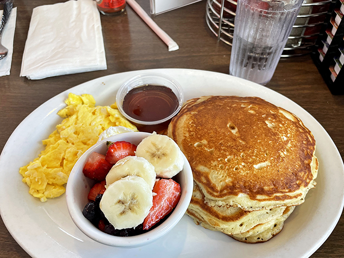 The breakfast stack that launched a thousand food dreams—pancakes, fresh fruit, and eggs that remind you why morning meals matter.