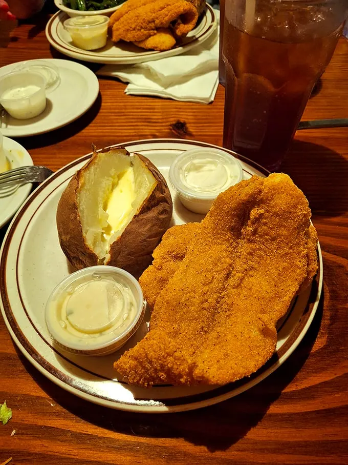 Golden-fried catfish and a butter-slathered baked potato – comfort food that speaks the universal language of "you're gonna need a nap after this."