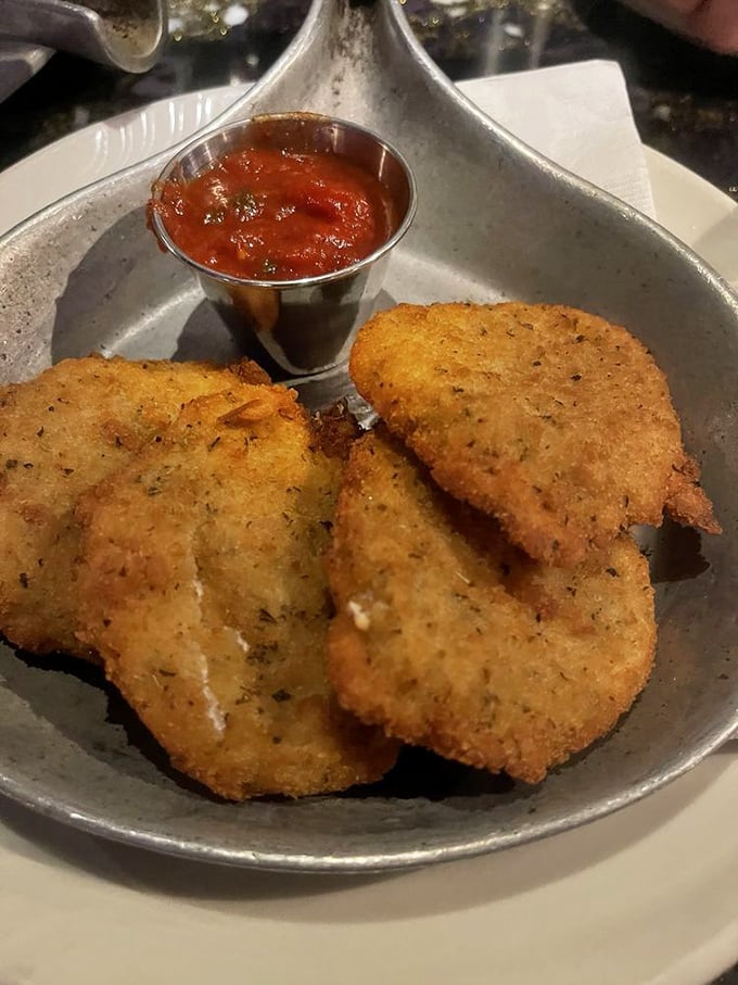 Fried mozzarella elevated from bar food to art form—golden-crisp outside, stretchy-melty inside, with marinara for dunking adventures.