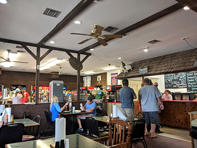 No fancy frills here—just wooden tables, ceiling fans, and the promise of barbecue that will haunt your dreams in the best possible way.