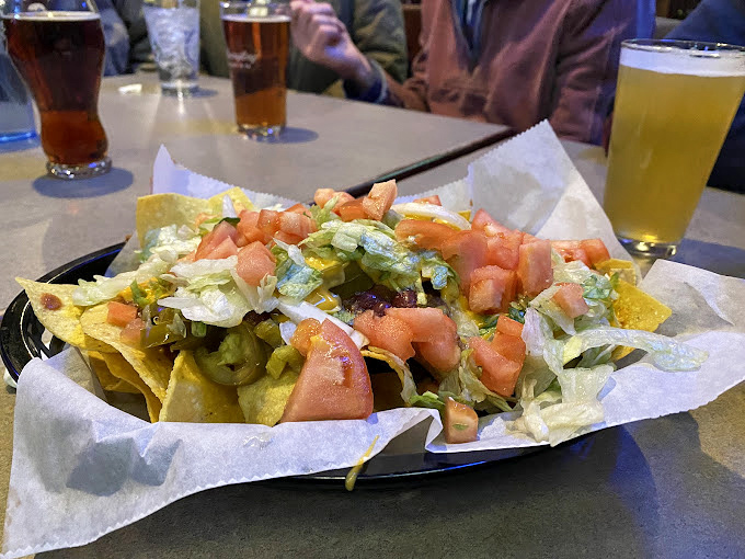 These loaded nachos aren't just a starter—they're a commitment. A glorious mountain of chips, cheese, and toppings that demands to be shared.