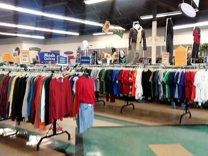 Department store-style signage guides you through the thrifting wilderness, proving organization is possible even in secondhand paradise.
