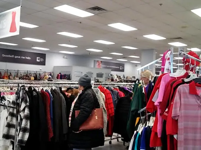 The thrill of the hunt in action! Shoppers navigate the wilderness of winter coats, each hoping to discover that elusive designer label hiding in plain sight.