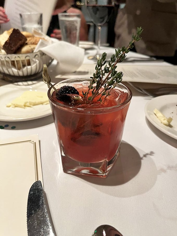 Not just a cocktail but a work of art with that sprig of thyme standing tall like it's claiming this drink in the name of sophisticated sipping.
