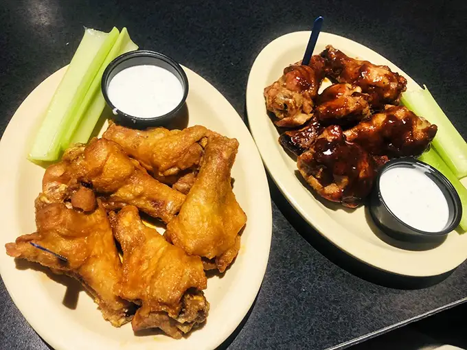 Wing perfection in two distinct styles—one crispy, one saucy. The Switzerland of the eternal buffalo wing debate: neutrally delicious.
