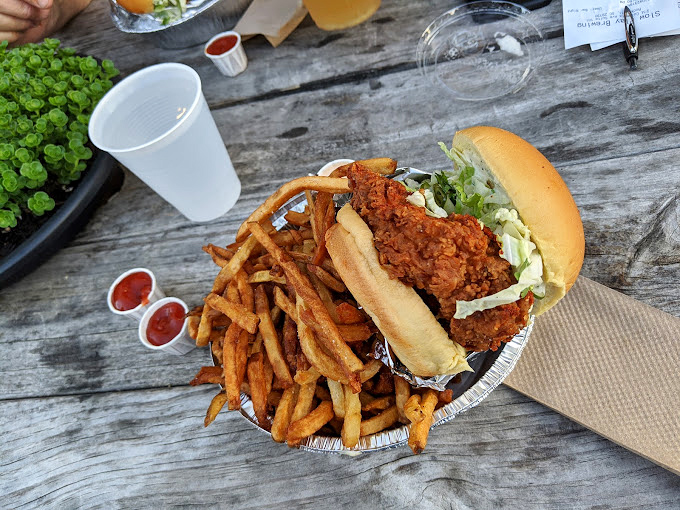 Fried chicken sandwich perfection—crispy exterior, juicy interior, and enough fries to share (though you probably won't want to).