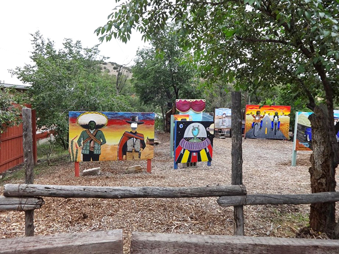 Folk art comes alive in this outdoor gallery, where painted panels celebrate New Mexico's cultural heritage under the watchful gaze of cottonwood trees.