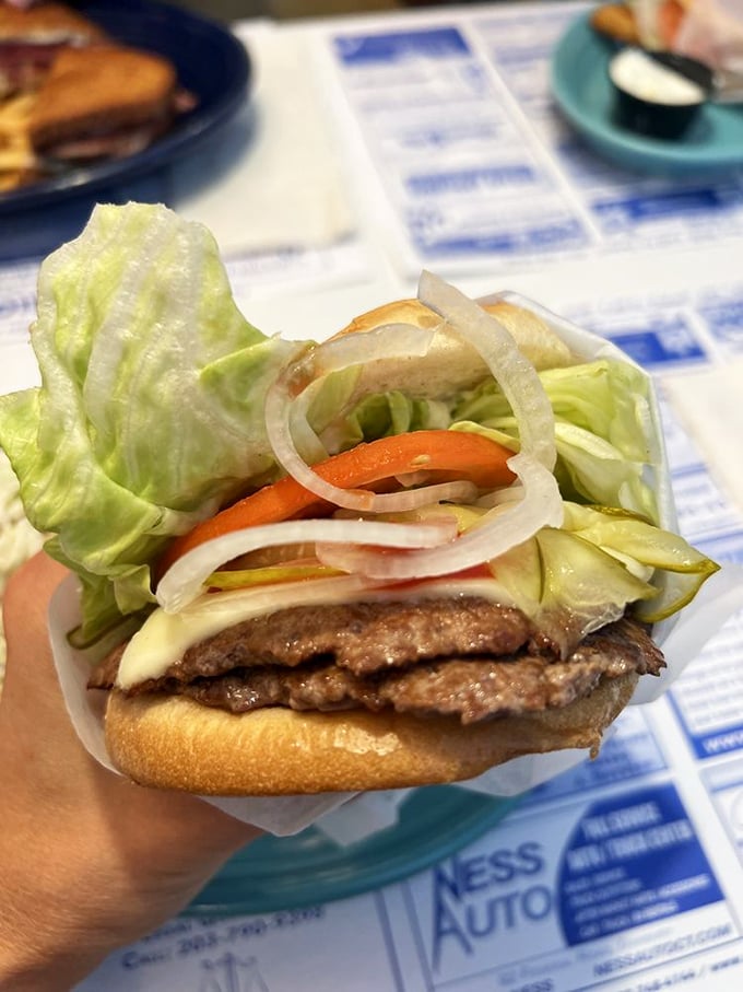 This isn't just a burger—it's a perfectly constructed Dagwood, where each fresh ingredient plays its essential role in the symphony.