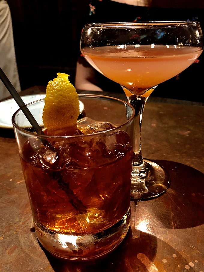 Cocktail artistry at its finest—an Old Fashioned that would make Don Draper weep with joy alongside a martini that whispers sophistication.