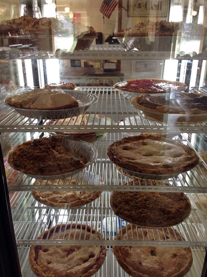 The pie case—Kansas's version of the Louvre. Each shelf displays masterpieces that took generations to perfect and seconds to appreciate.