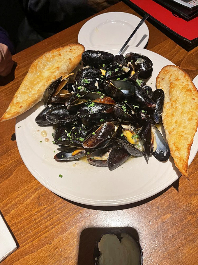 These mussels aren't just seafood—they're little black-shelled treasures bathing in a broth worth bottling and taking home.