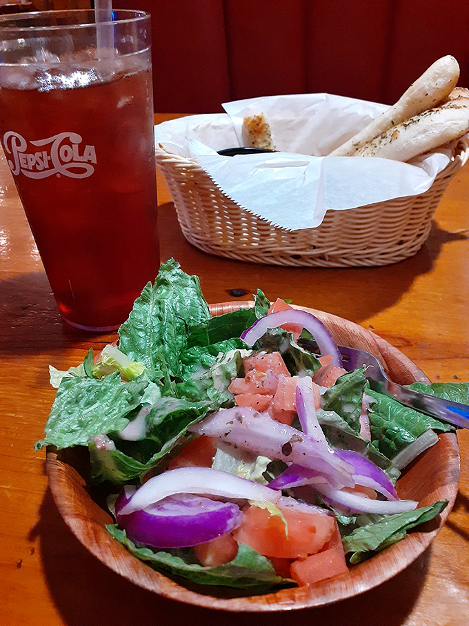 The opening act: crisp salad, warm breadsticks, and sweet tea—South Carolina's holy trinity of pre-pasta perfection.