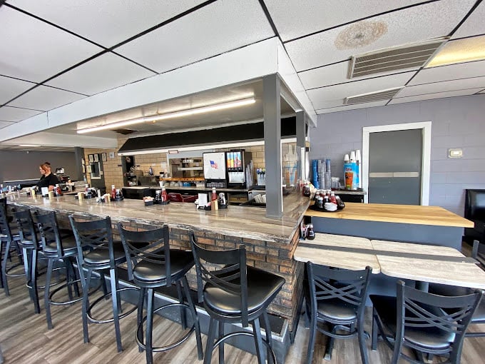 The counter seating—where solo diners become regulars and the staff eventually knows your order before you sit down.