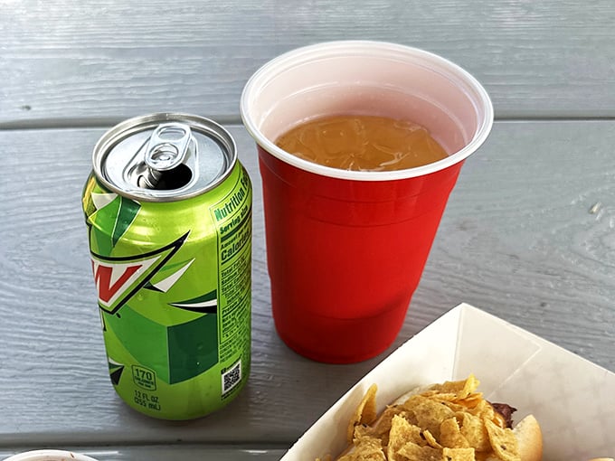 The holy trinity of casual dining: chips, soda, and the promise of a meal that requires no pretense—just pure, uncomplicated enjoyment.