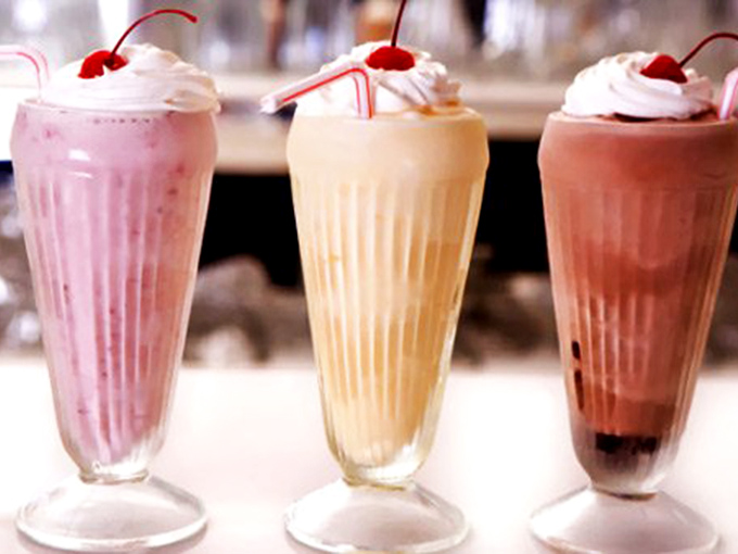 Milkshakes that blur the line between beverage and dessert, topped with whipped cream mountains and cherries that deserve their own ZIP code.