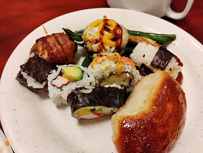 Sushi rolls nestled beside a golden dinner roll – proof that World Buffet understands the importance of diplomatic relations between cuisines. 