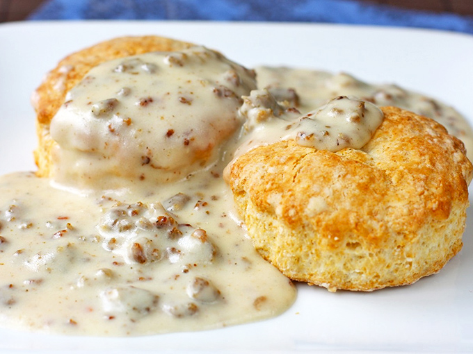 These aren't just biscuits and gravy – they're edible clouds swimming in savory heaven, the kind of breakfast that makes you rethink your morning routine.