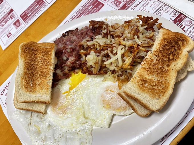 The holy trinity of breakfast: perfectly cooked eggs, crispy hash, and golden toast – a plate that says "good morning" better than words ever could.